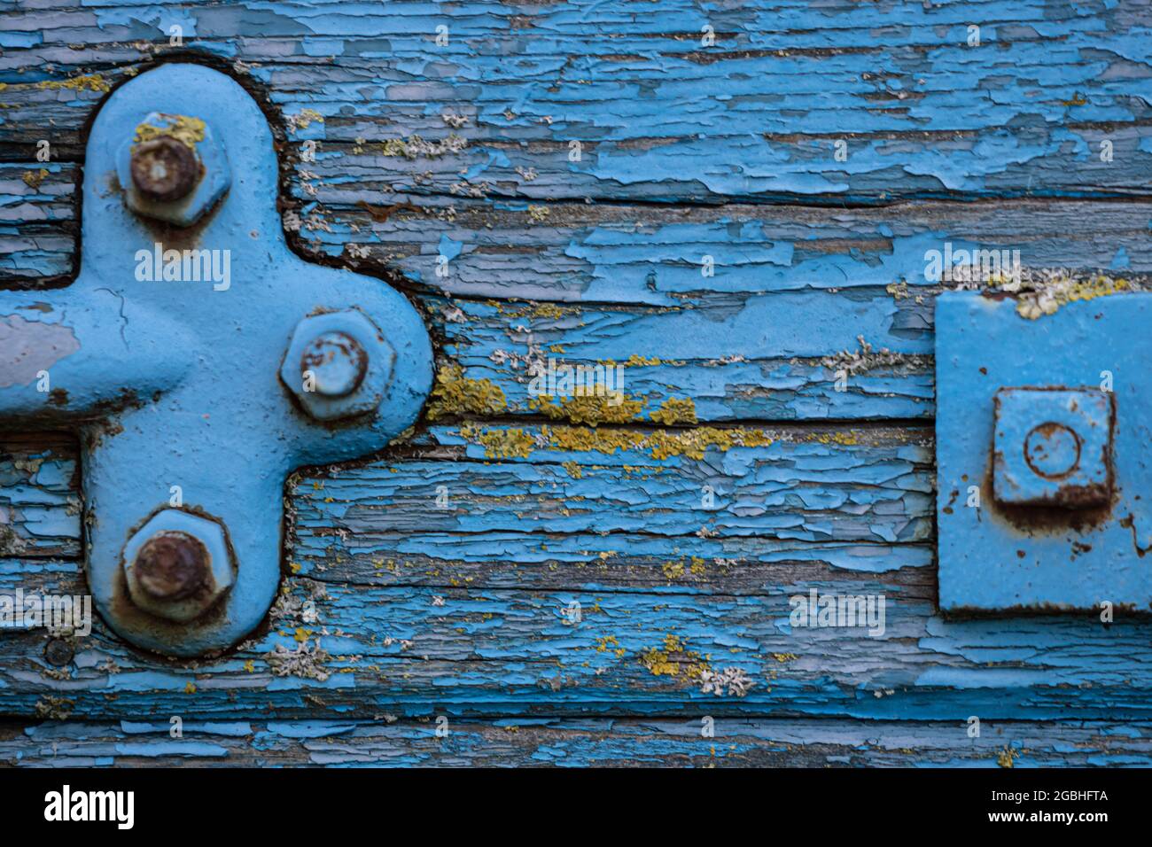 Closeup shot of nails and a broken handle on an old blue-painted wall ...