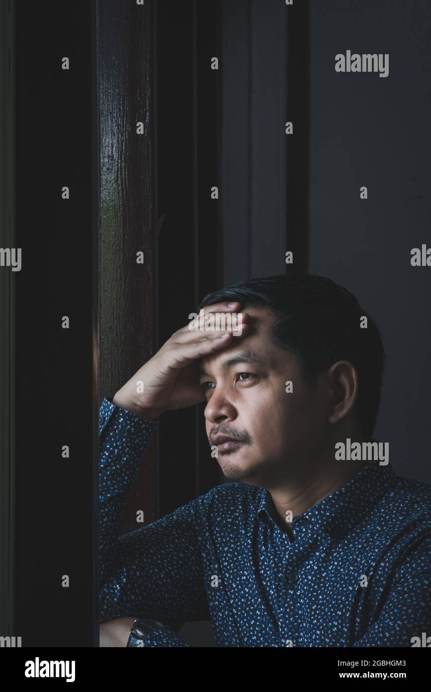 Sad man thinking and looking out the window Stock Photo - Alamy