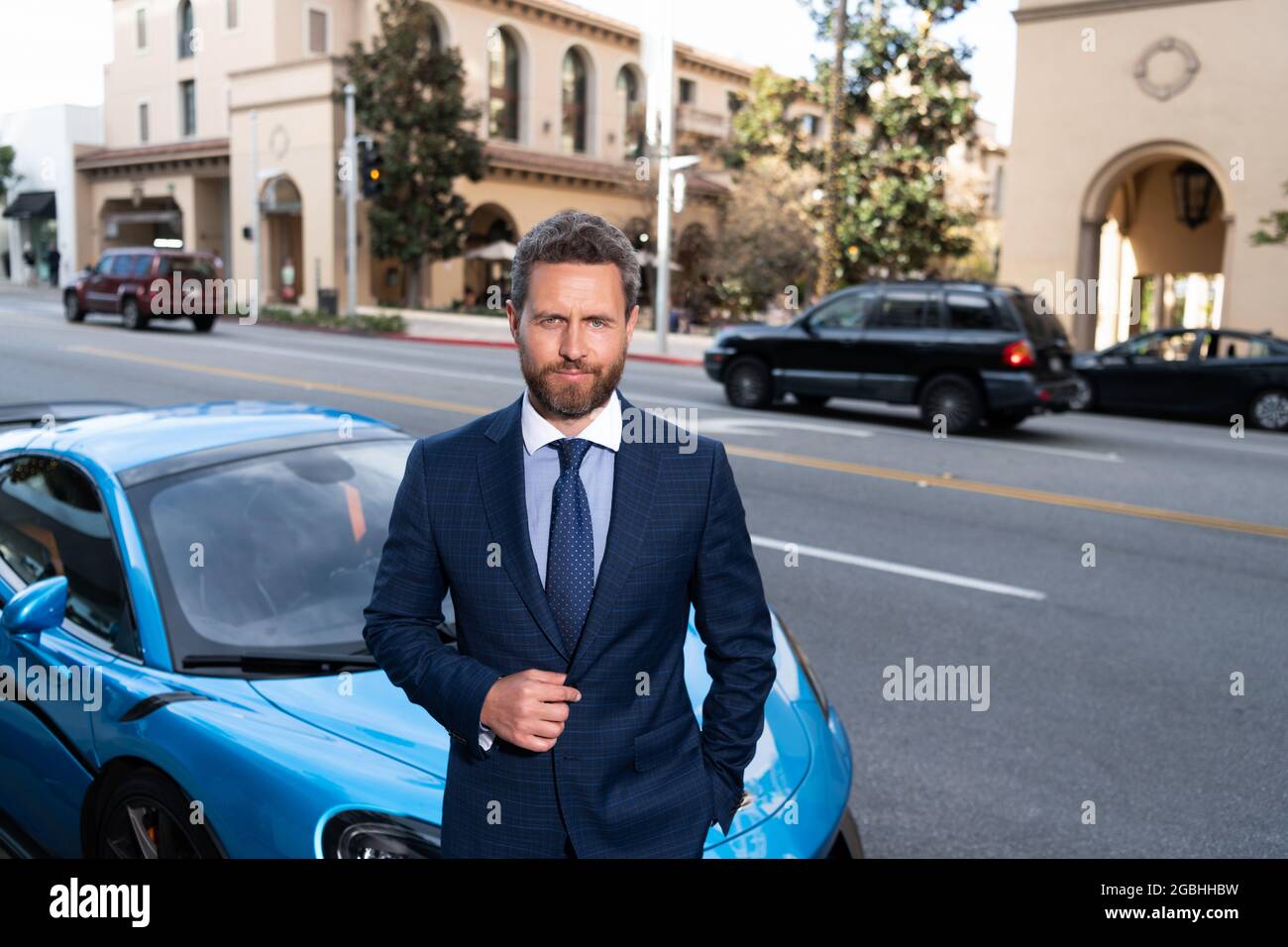 handsome man in expensive suit. confident business executive rent car ...