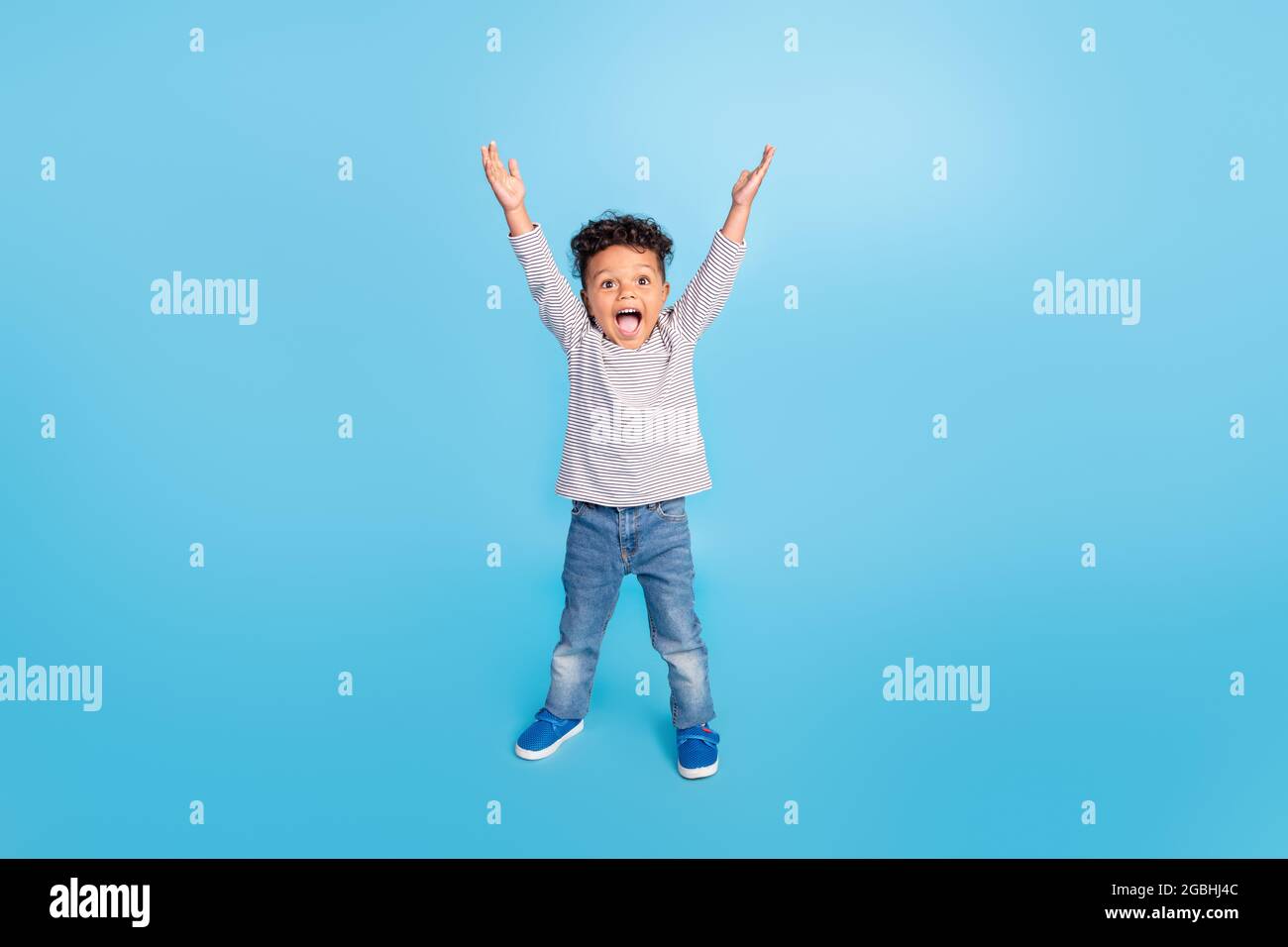Full length body size view of attractive cheerful boy rising hands up ...