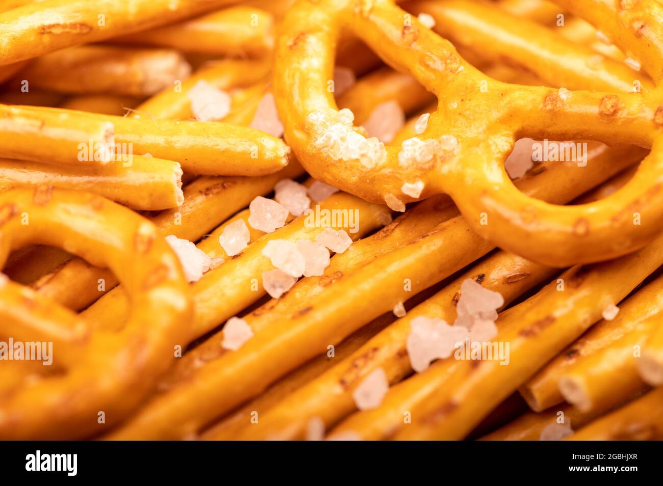 Bread sticks and bread figures with salt. Close-up Background image ...