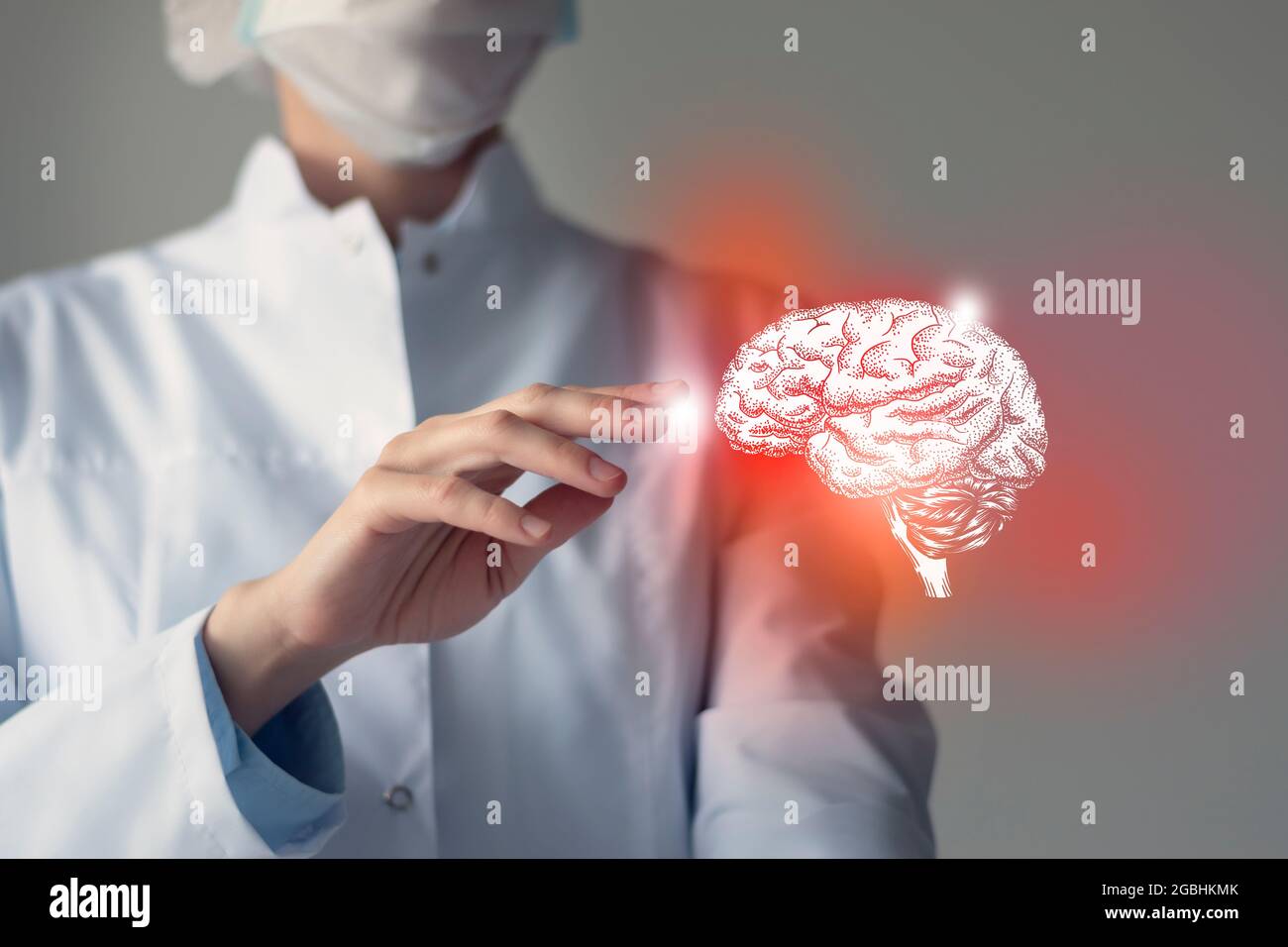 Female doctor touches virtual red Brain in hand. Blurred photo ...