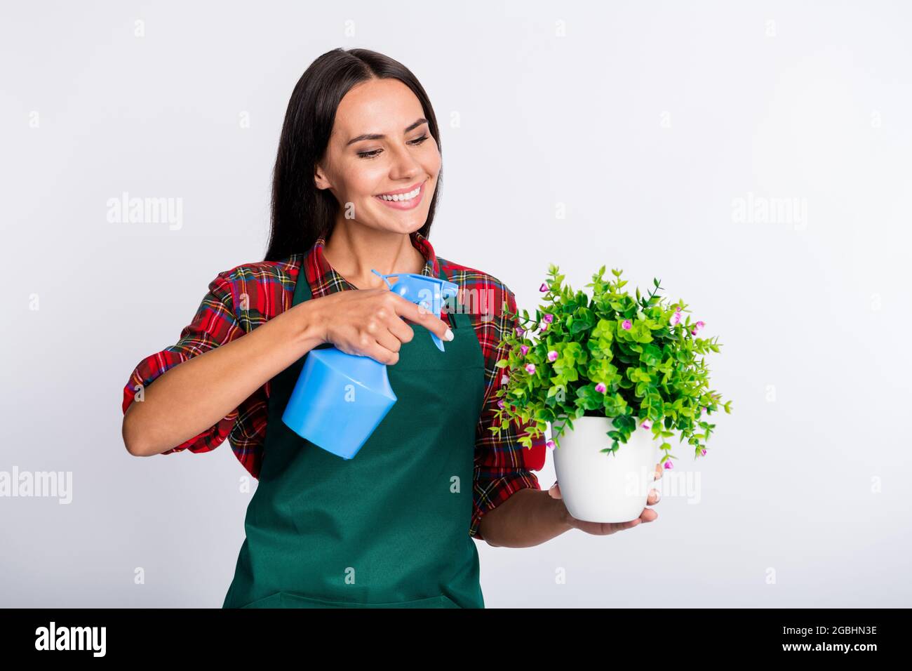 Photo of happy cheerful young woman look water plant occupation garden ...