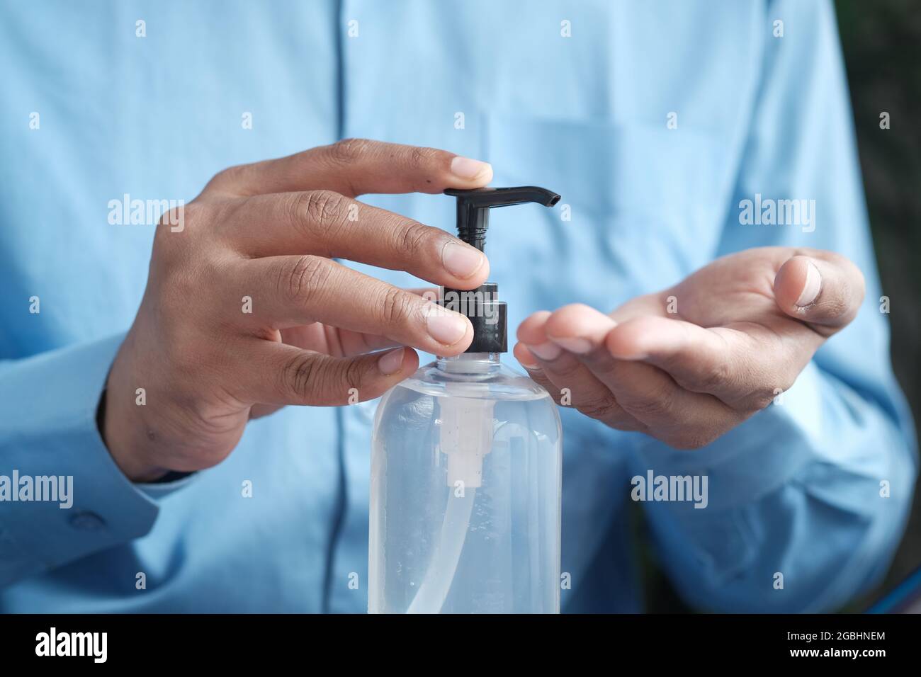 Using sanitizer liquid for preventing corona virus Stock Photo - Alamy