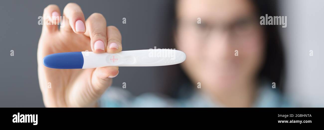 Woman holds pregnancy test in her hand Stock Photo - Alamy