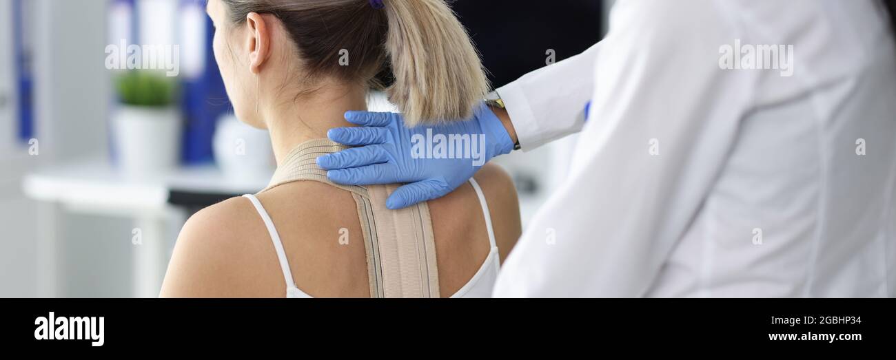 Doctor fixes posture corrector to patient closeup Stock Photo - Alamy