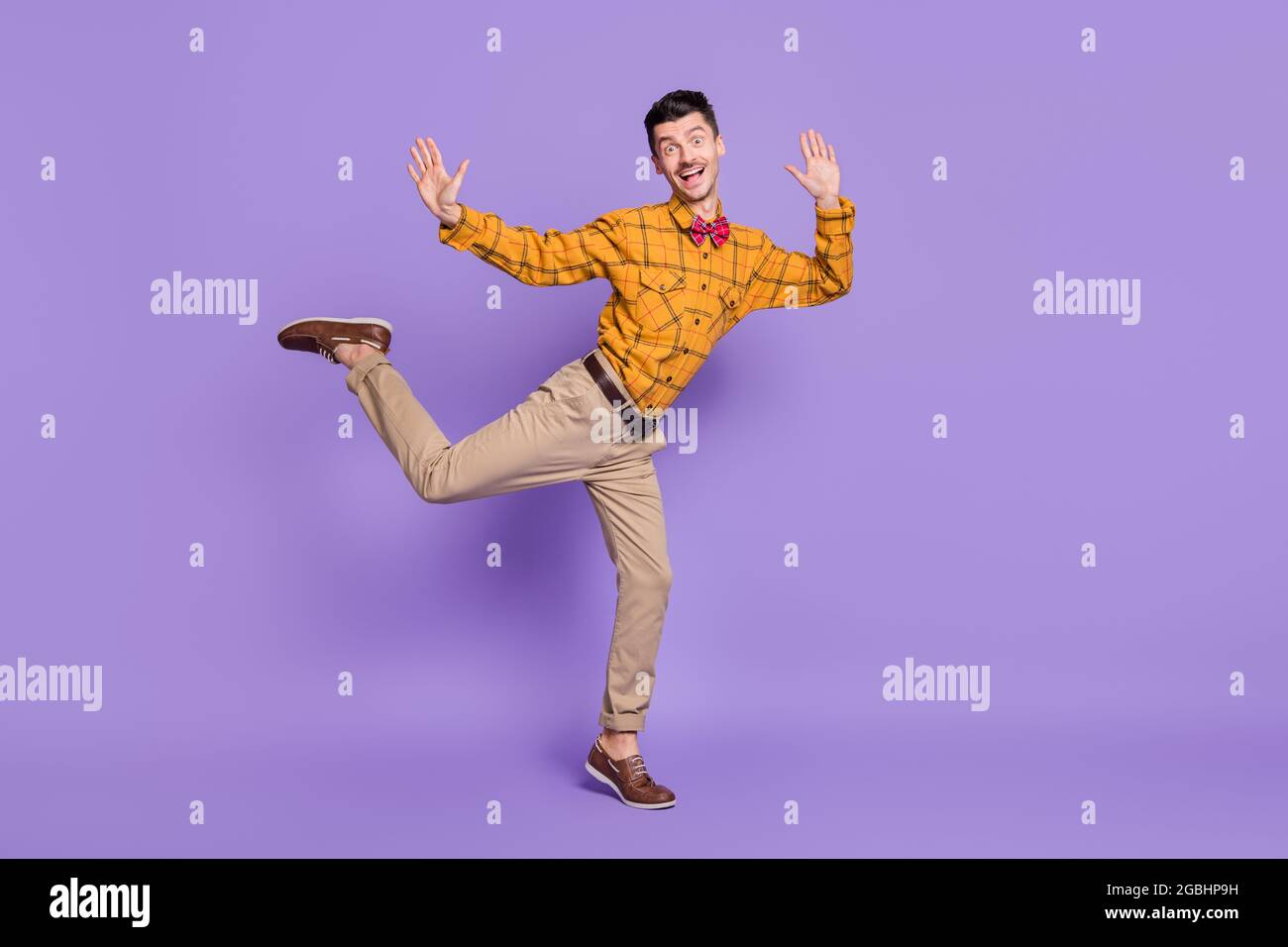Photo of funny cute young guy dressed checkered shirt dancing standing ...