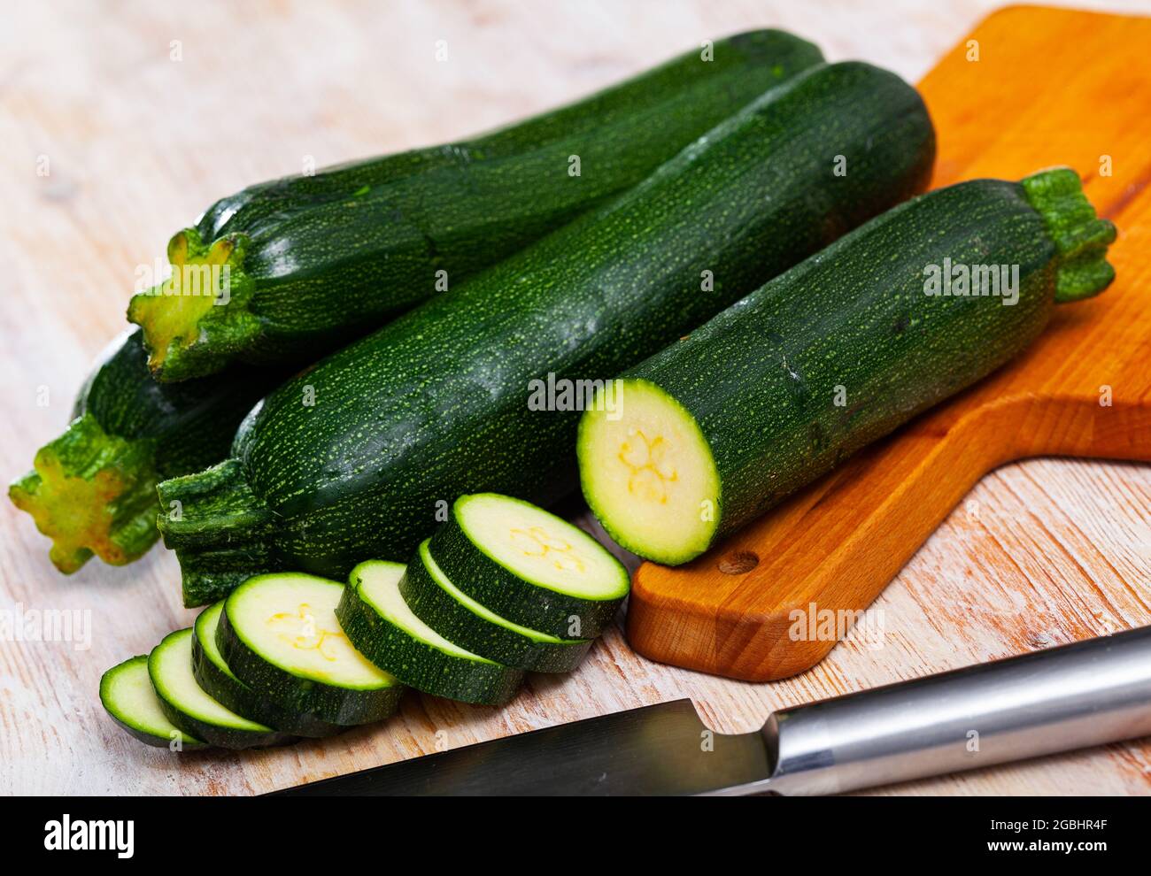 Sliced zucchini on wooden table Stock Photo - Alamy