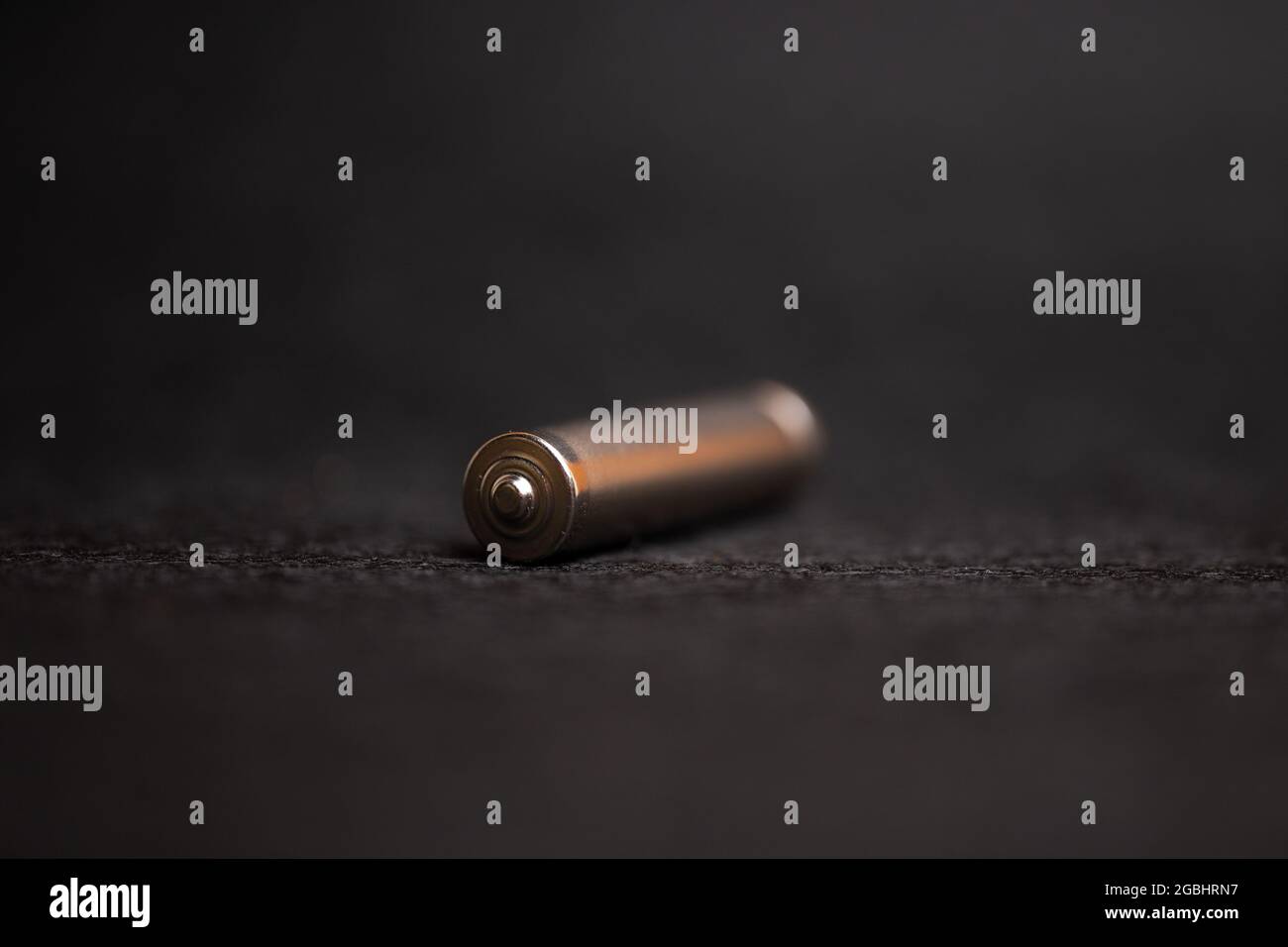 metal AAA battery on a black background Stock Photo - Alamy