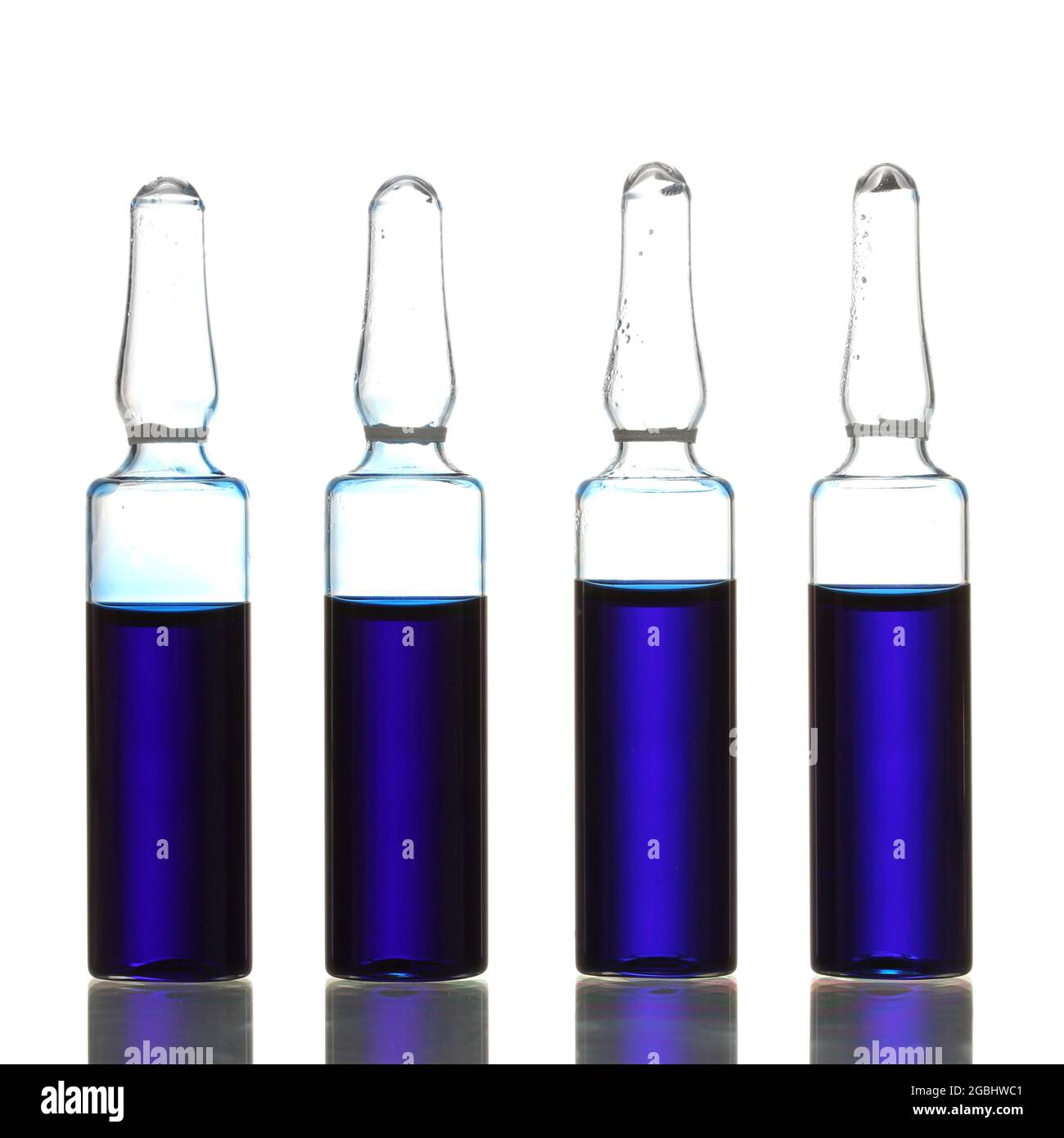 medical ampules with blue liquid, isolated on white Stock Photo - Alamy
