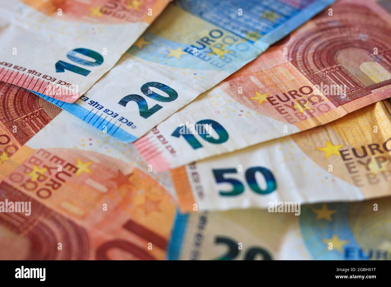 Euro banknotes. table covered with banknotes Stock Photo - Alamy