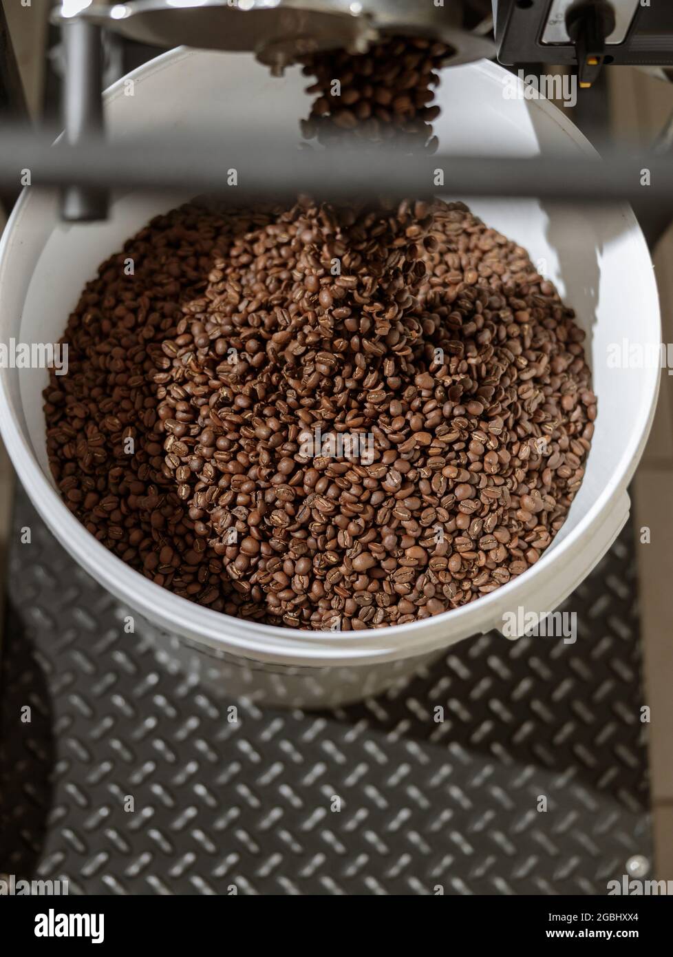 Plastic bucket with coffee beans under bean release chute Stock Photo ...
