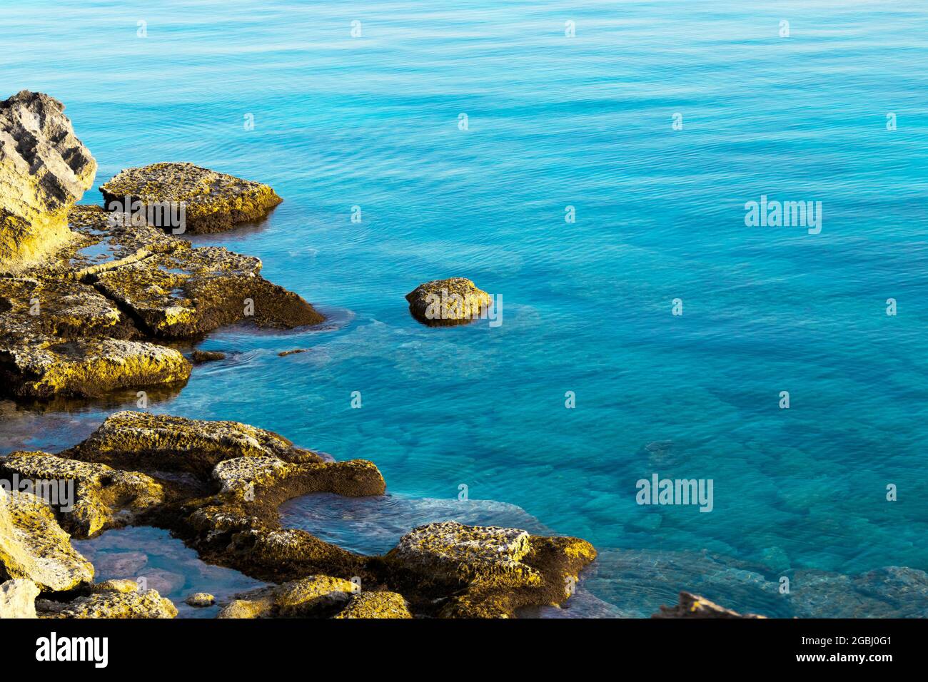 Mediterranean sea beach. Stones and Rocks. Summer day seascape. Clear ...