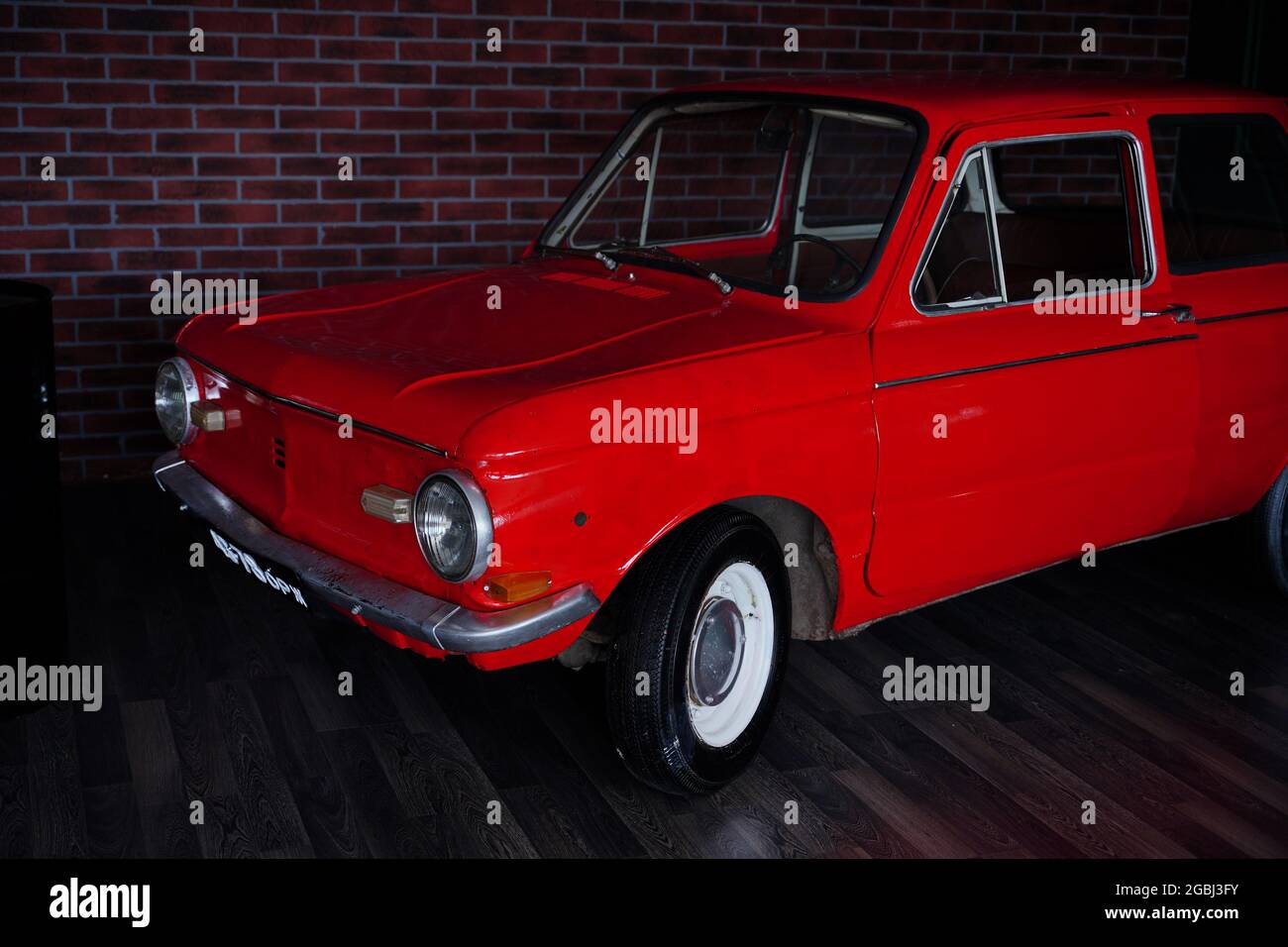 vintage old red car in front of brick wall Stock Photo - Alamy