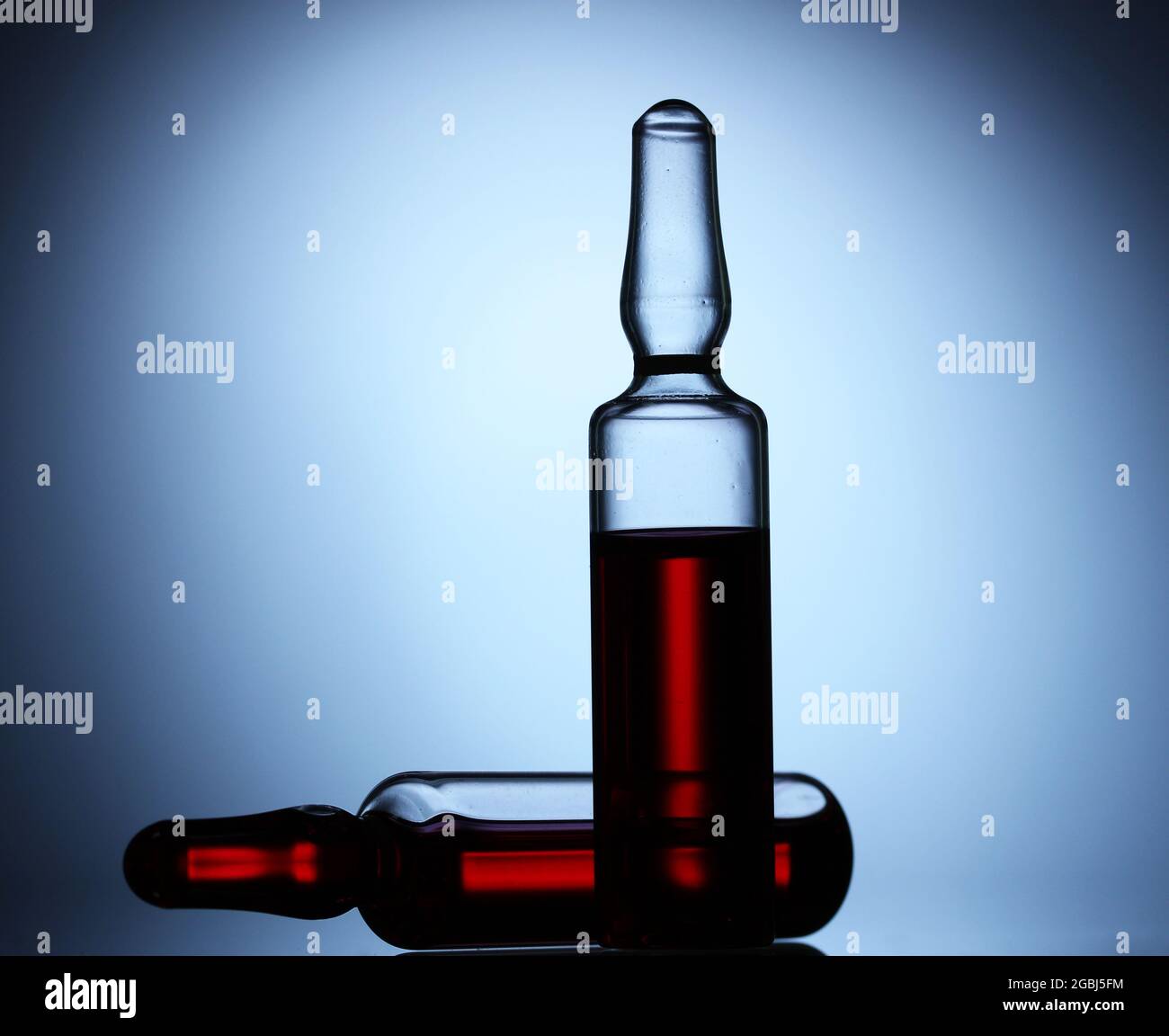 medical ampules on blue background Stock Photo - Alamy