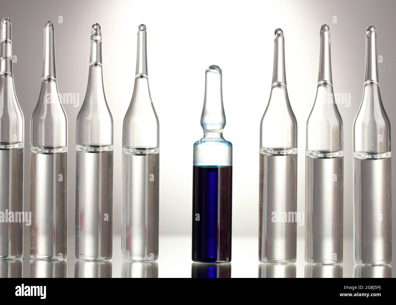 medical ampules on grey background Stock Photo - Alamy