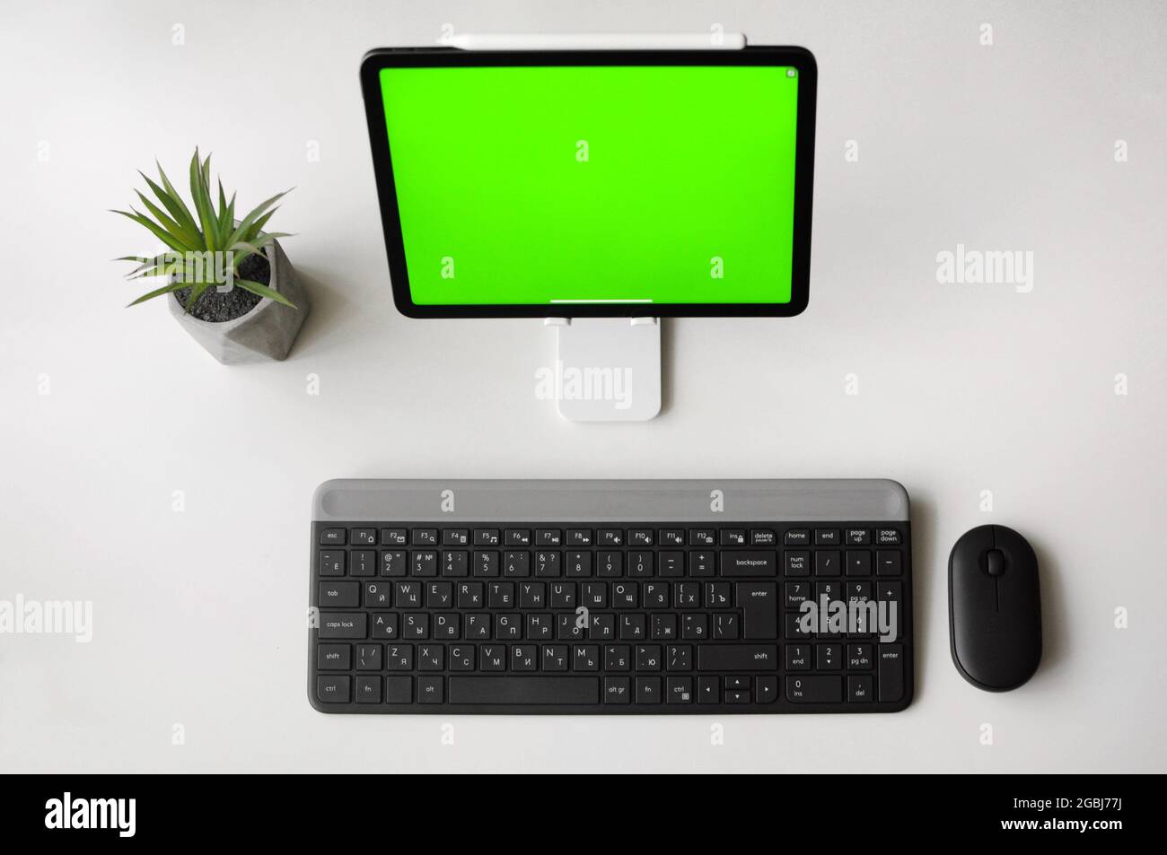 Home office workplace with the tablet device on table with stand and ...