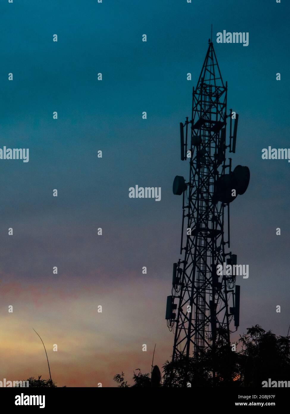 Telecommunication tower against a dusky sunset sky Stock Photo - Alamy