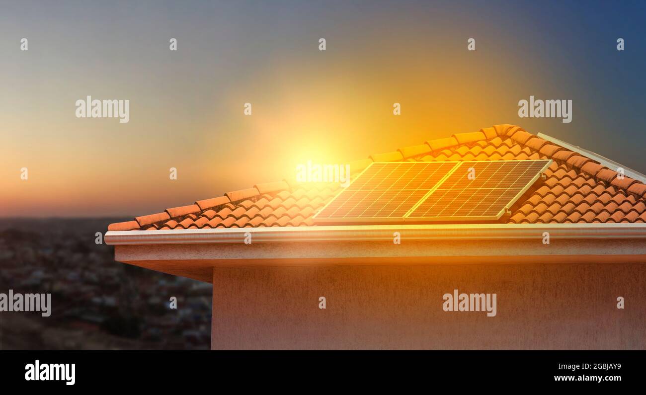 Solar energy panels over a beautiful sunset sky city backgound Stock ...