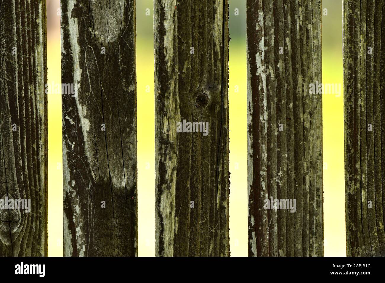 Wooden Fence With Perpendicular Columns And Yellow Background Stock ...