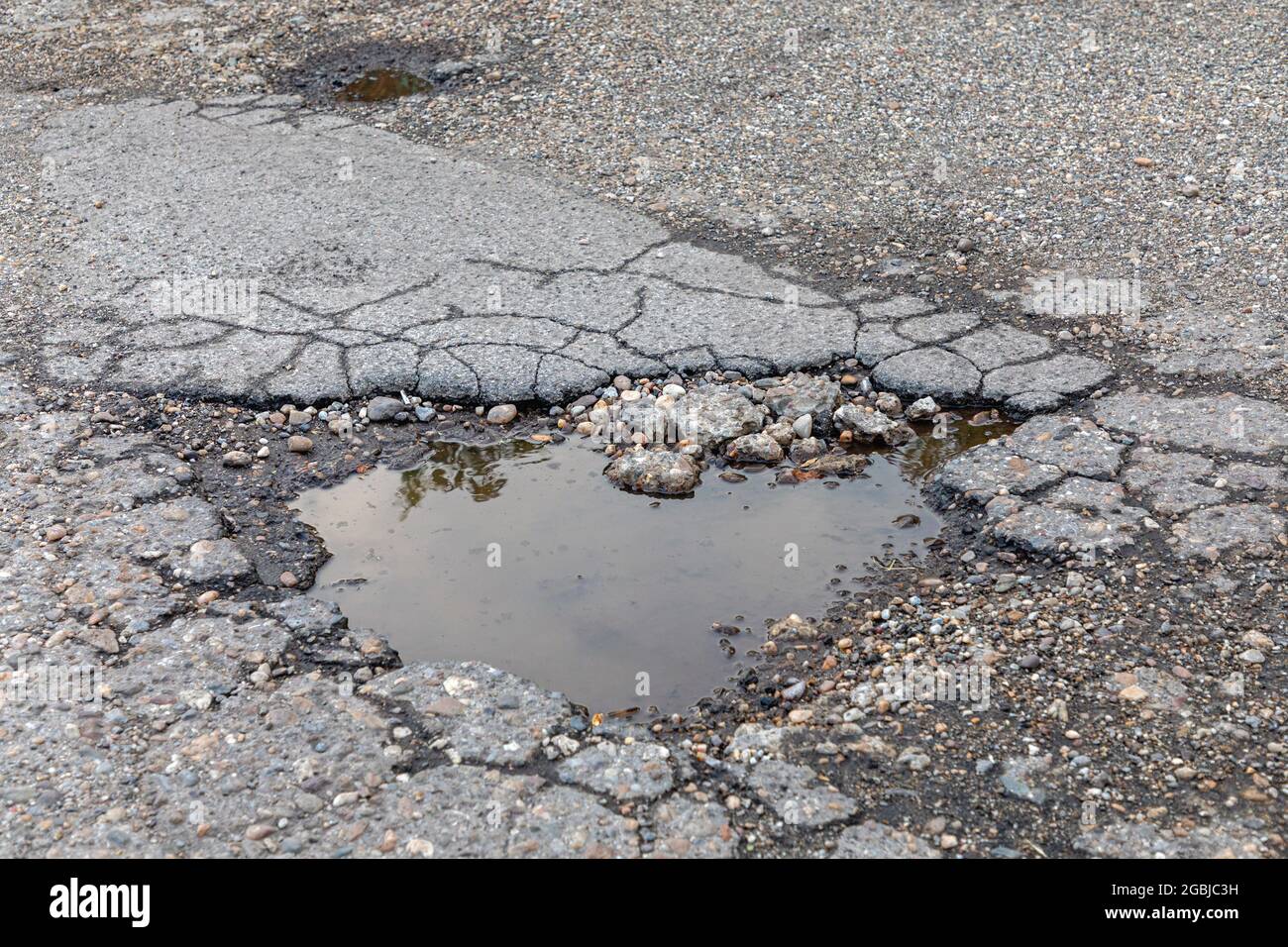Big Pot Hole Filled With Rain Water Damaged Street Problem Stock Photo ...