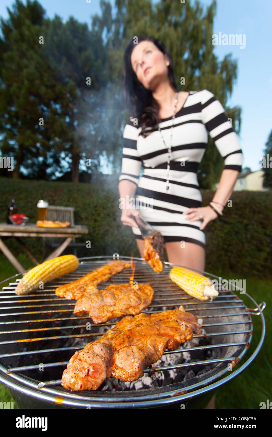 Woman grilling corn hi-res stock photography and images - Alamy