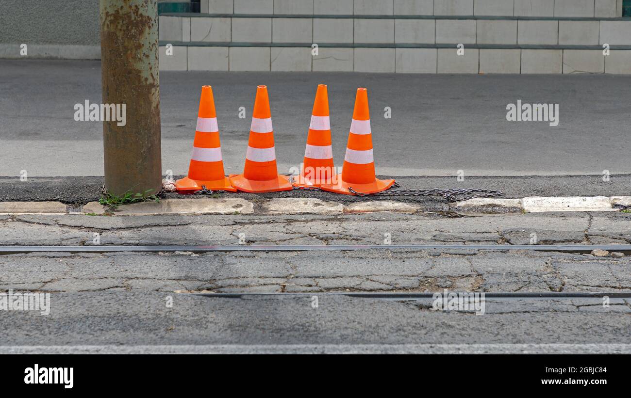 Orange Traffic Cones Chained to Pole at Street Stock Photo - Alamy