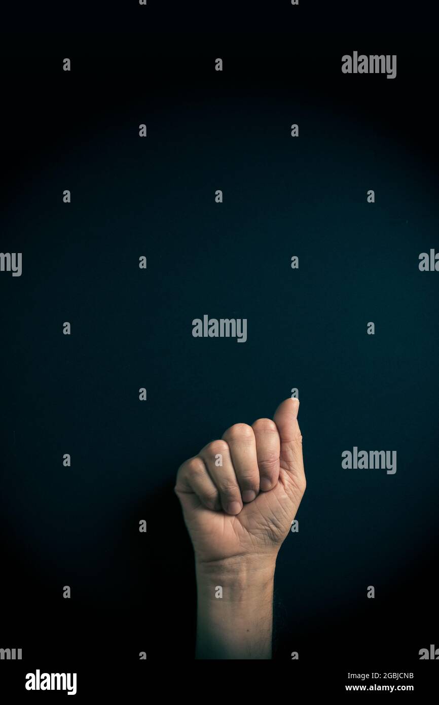 Dramatic colour image of male hand demonstrating ASL American sign ...