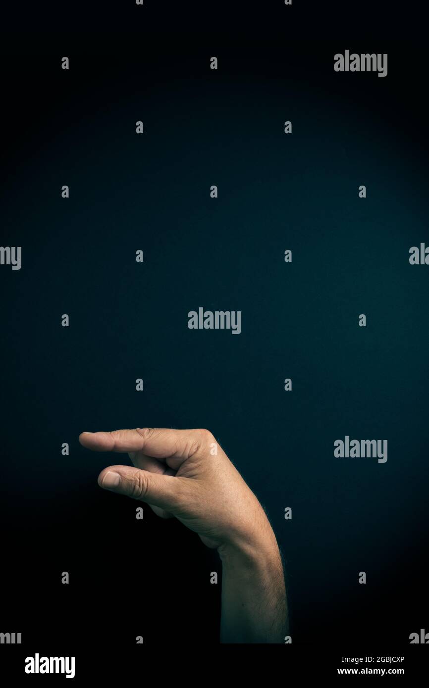 Dramatic colour image of male hand demonstrating ASL American sign ...