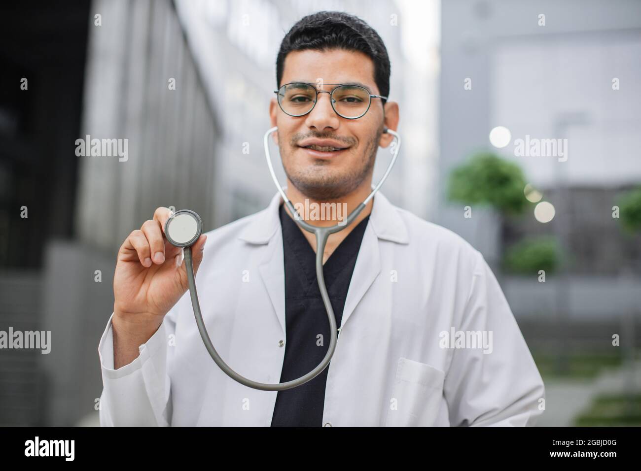 Portrait of smiling friendly male Arab hindu doctor or medical student ...