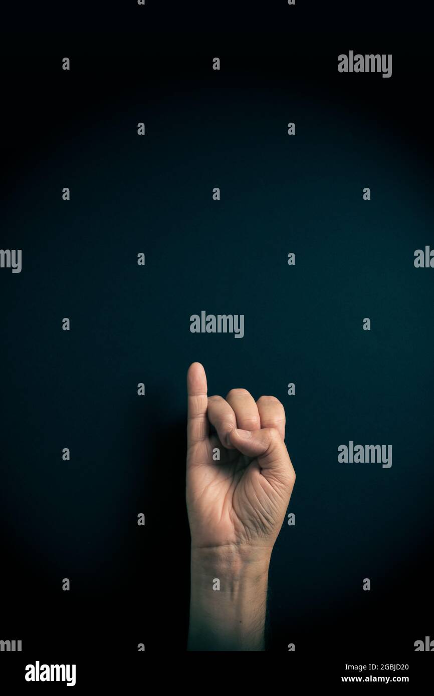 Dramatic colour image of male hand demonstrating ASL American sign ...
