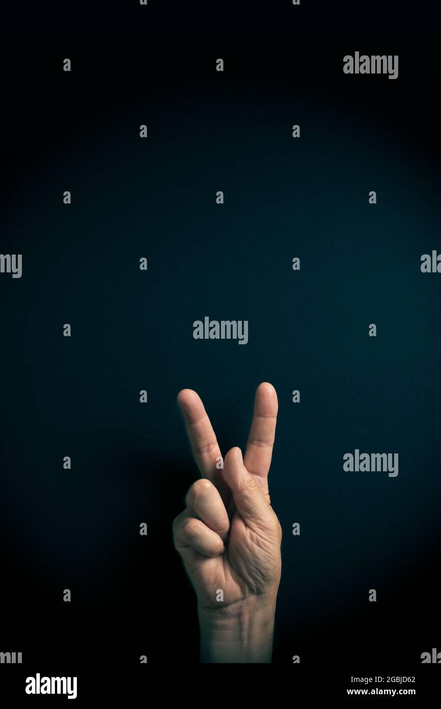 Dramatic colour image of male hand demonstrating ASL American sign ...