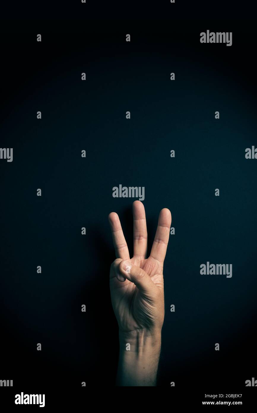 Dramatic colour image of male hand demonstrating ASL American sign ...