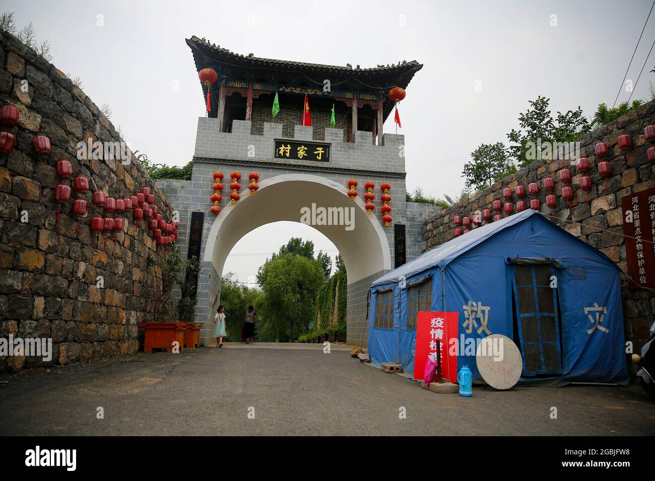 Check points are set up at a gate to a rural village to measure ...