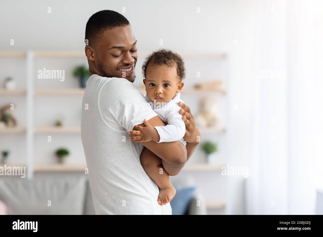 Happy Black Dad Spending Time At Home With His Cute Infant Baby Stock ...