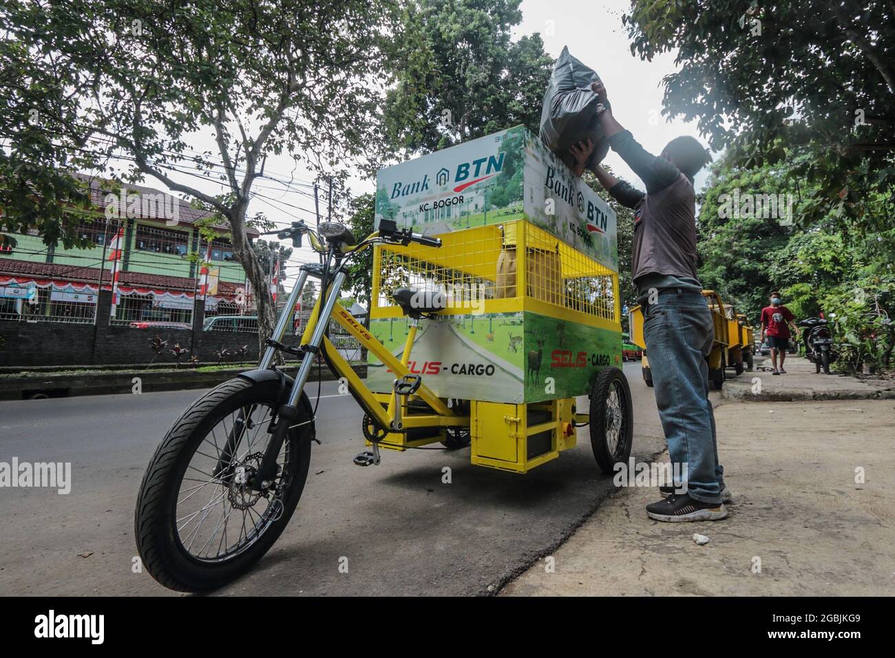 An officer is seen loading garbage into an electric bicycle that ...