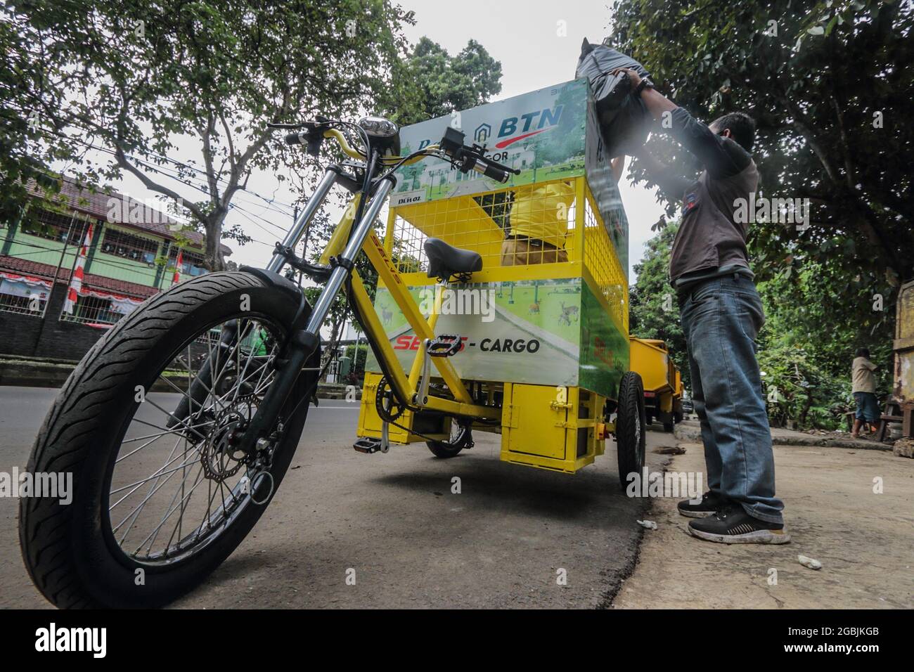 An officer is seen loading garbage into an electric bicycle that ...