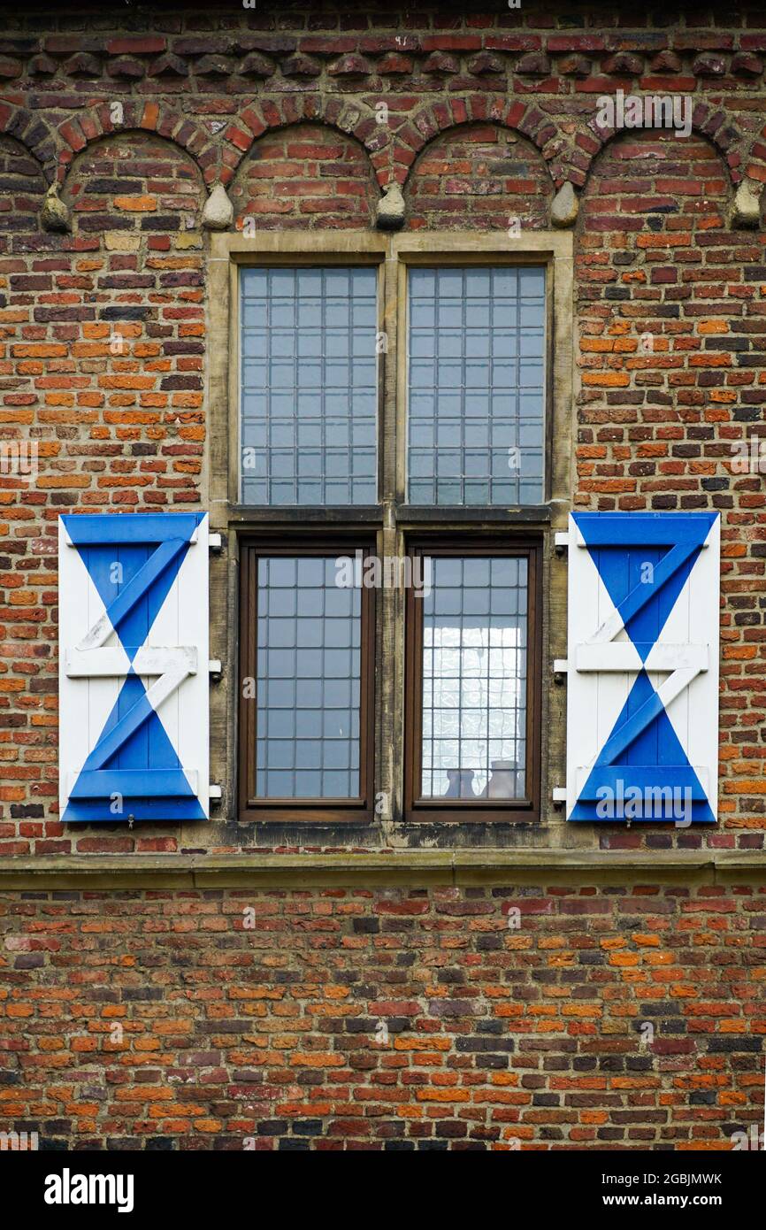 Antique facade of a building with medieval windows Stock Photo - Alamy