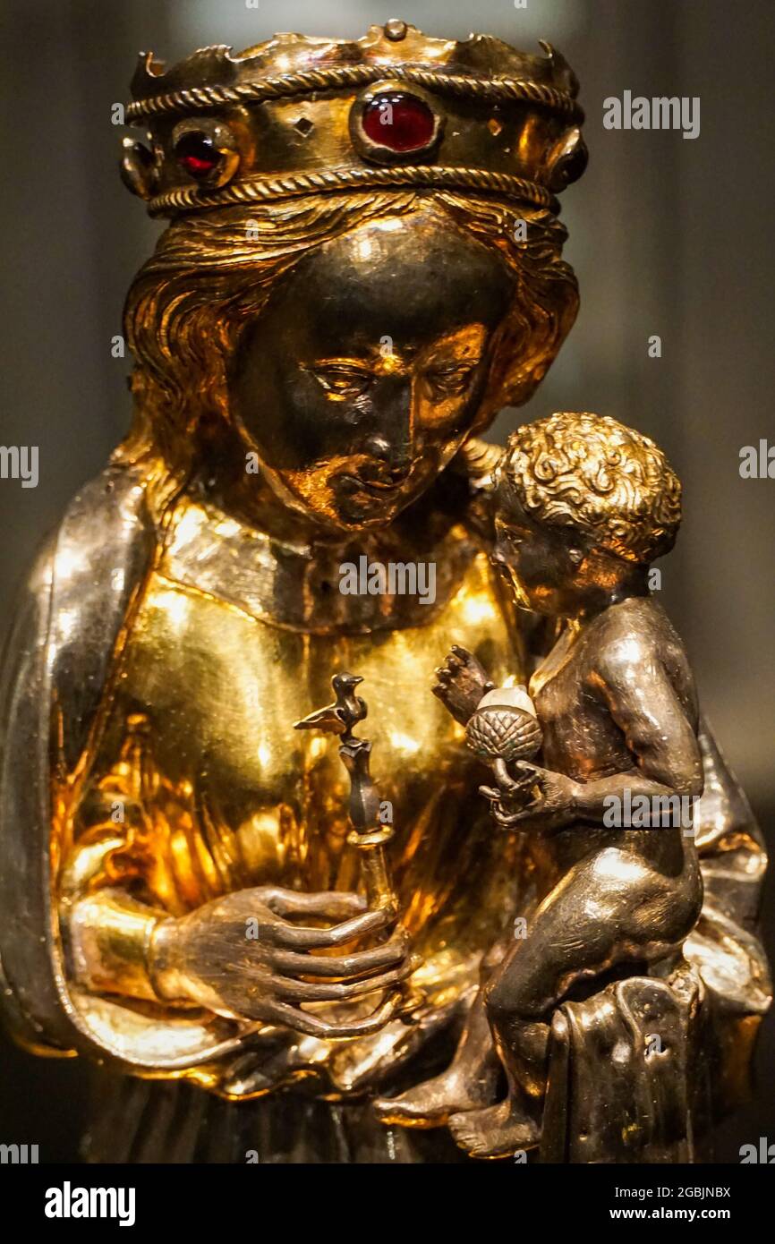 Golden statue of a female saint with her baby Stock Photo - Alamy
