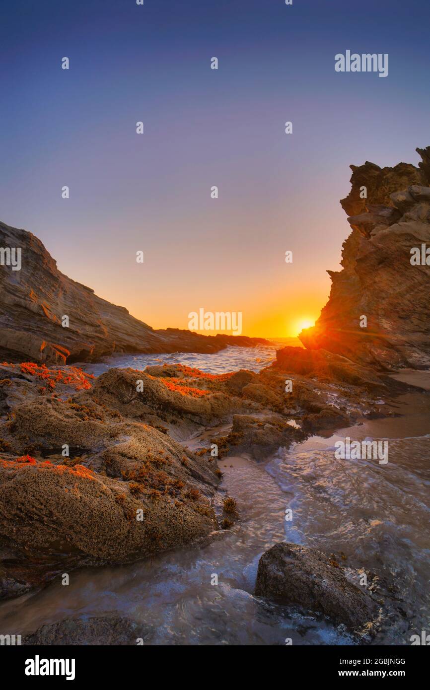 Beautiful scenery of cliffs by the sea at sunset Stock Photo - Alamy