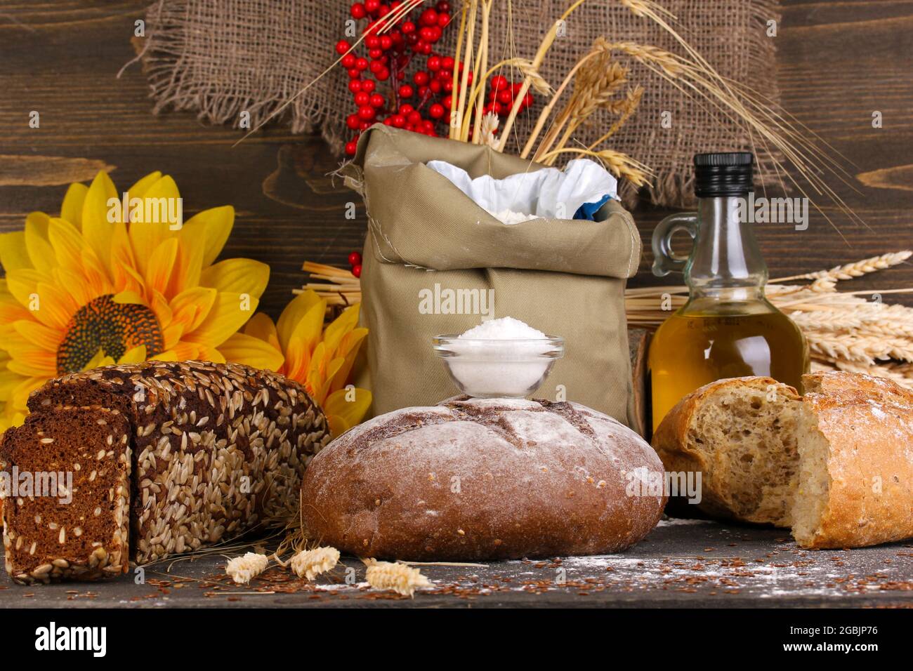 Different types of rye bread on wooden table on wooden background Stock ...