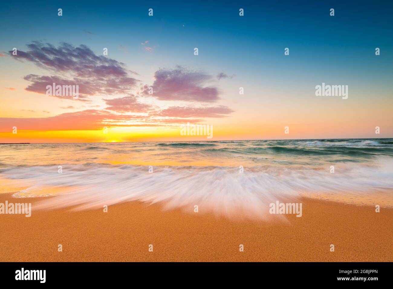 Beautiful cloudscape over the sea, sunrise over ocean waves and beach ...