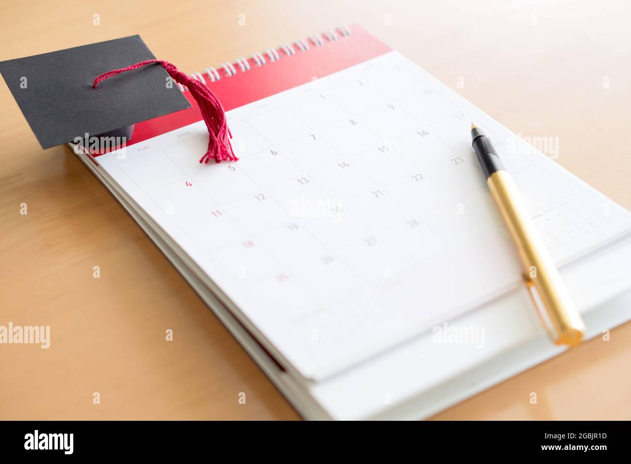 Pen on calendar and Graduation cap Stock Photo - Alamy
