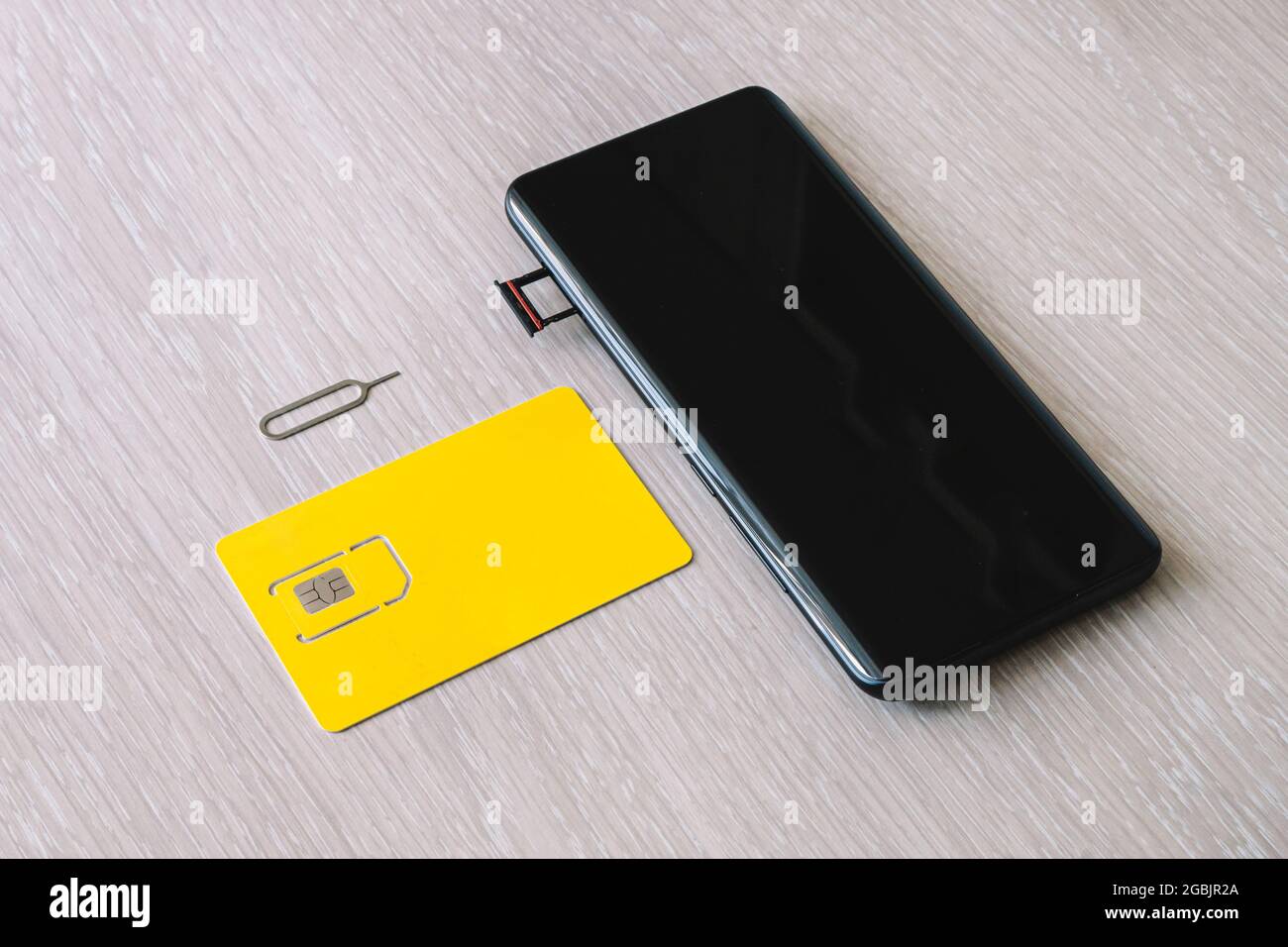 SIM card and microSD card tray with removal tool at the side of ...