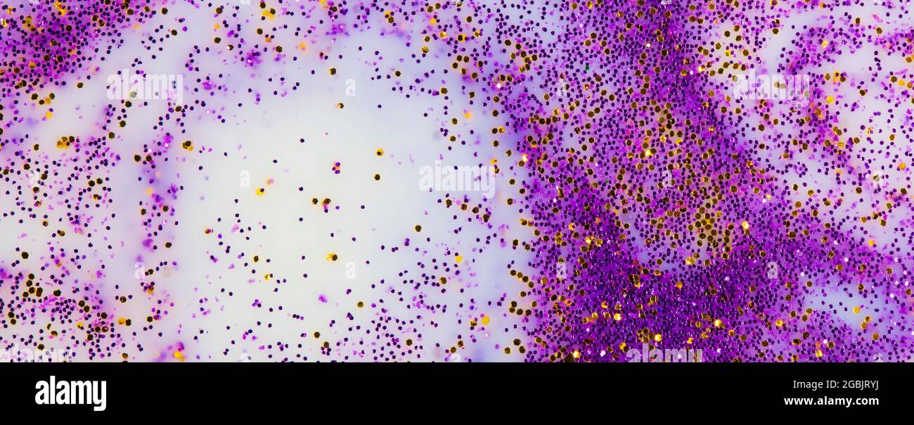 Festive or glamorous background. Gold and purple sparkles scattered on ...