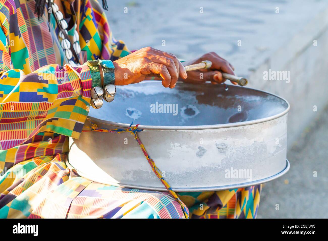 African musician in a colorful dress playing a musical instrument Stock ...