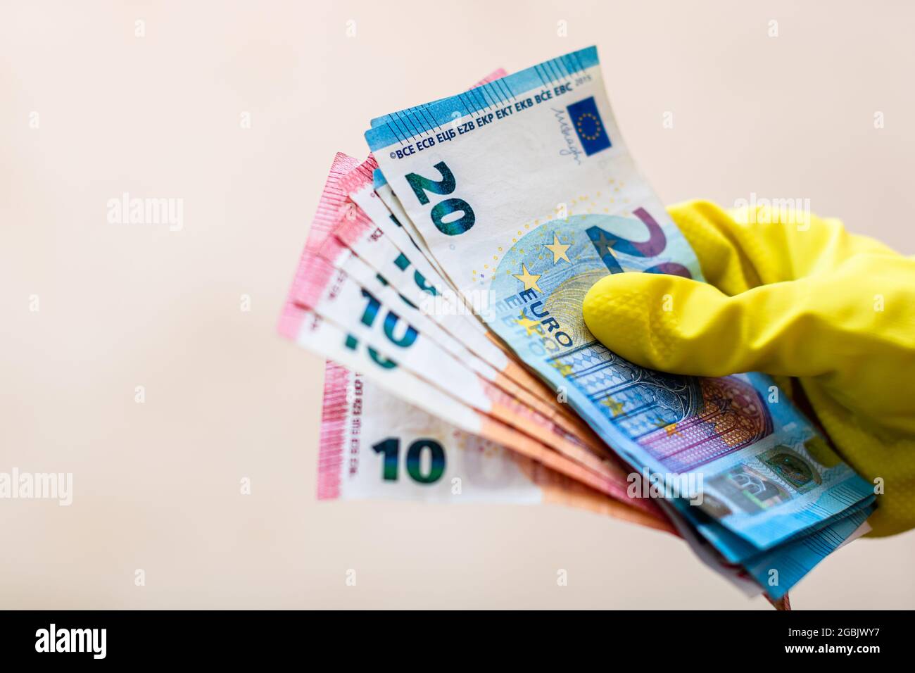 Hand with gloves receiving, giving or holding USD EURO banknote. World ...