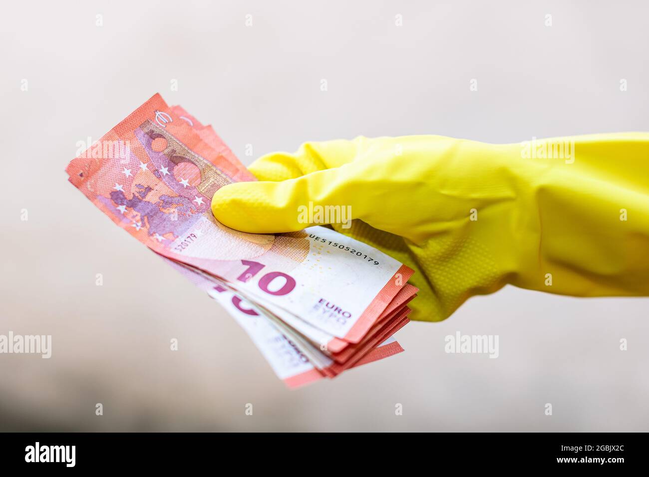 Hand with gloves receiving, giving or holding USD EURO banknote. World ...