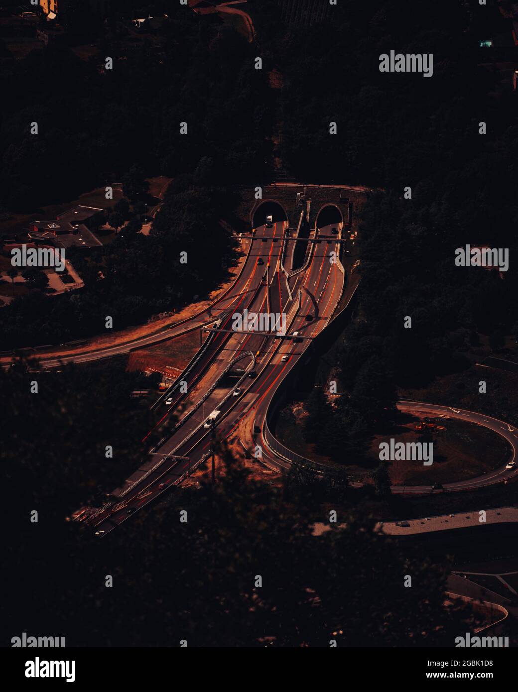 Aerial shot of controlled-access highways with two tunnels and moving ...