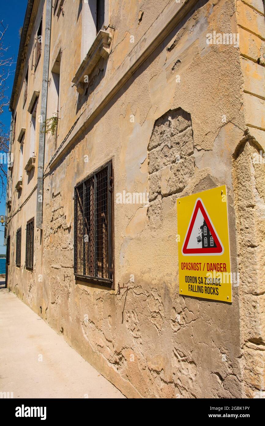 A sign on a derelict house warning people that the house is a danger ...